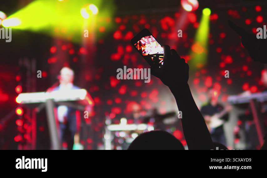 Iconic night rock concert front row crowd cheering hands in air Stock ...
