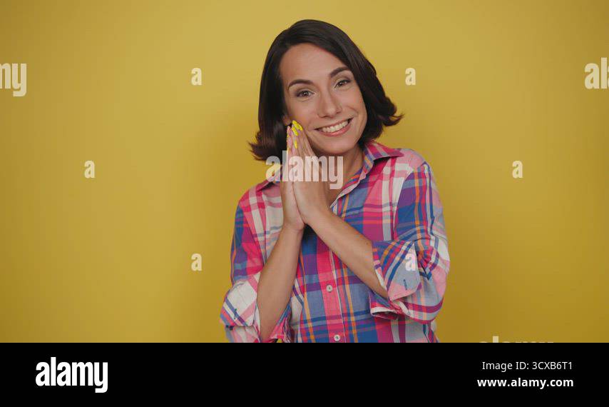 Charming woman expressing tenderness and saying good bye in plaid shirt ...