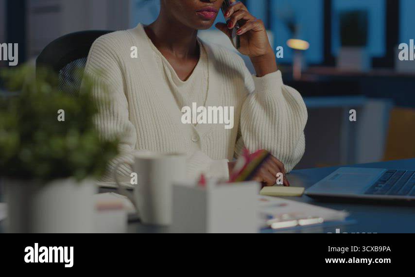Nervous african manager discussing at smartphone with employee Stock ...