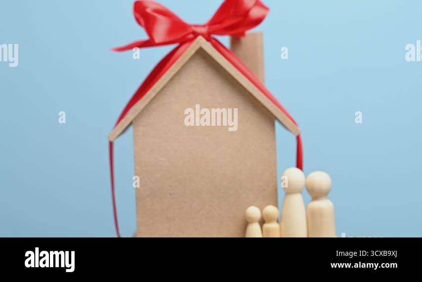female hand holds a metal key with a red ribbon on the background of a ...