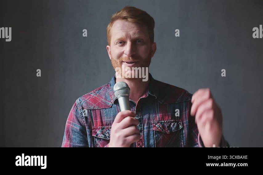 Handsome man making video talking in mic. Charming guy with golden ...