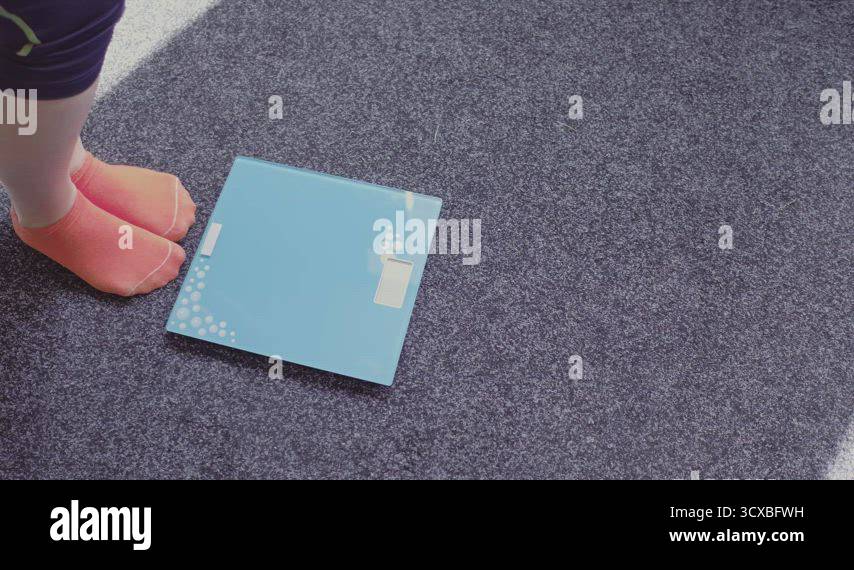 Checking weight on scales Stock Video Footage - Alamy