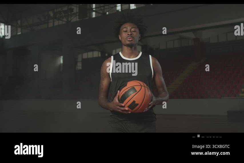 Video portrait of a basketball player bouncing a ball. African american ...
