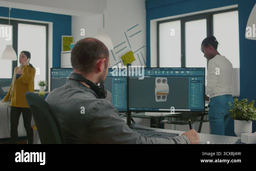Focused engineer putting on headphones working with technical cad ...