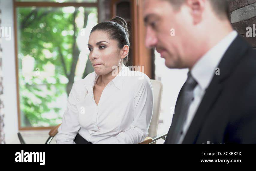A Business Man And a Business Woman are Sitting in a Conference Room ...