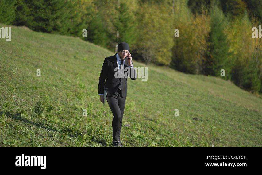Manager With Hat On His Head Is Talking On A Mobile Device While Being ...