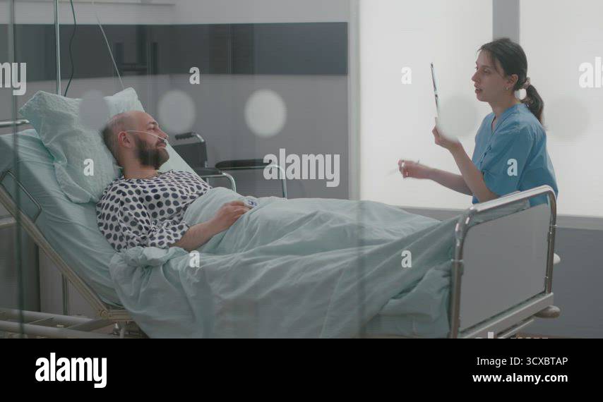 Medical nurse explaining bones radiography to hospitalized sick man ...