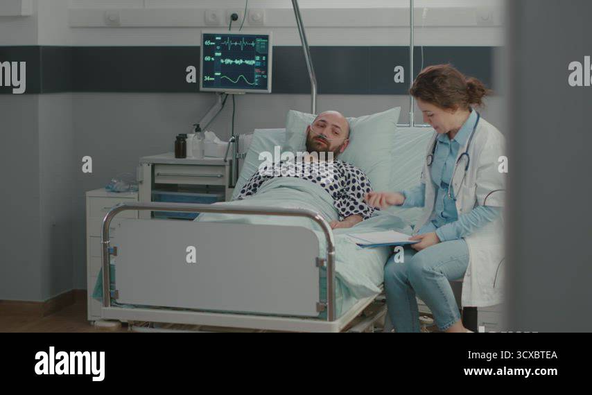Sick man resting in bed with oxygen tube talking with doctor explaining ...