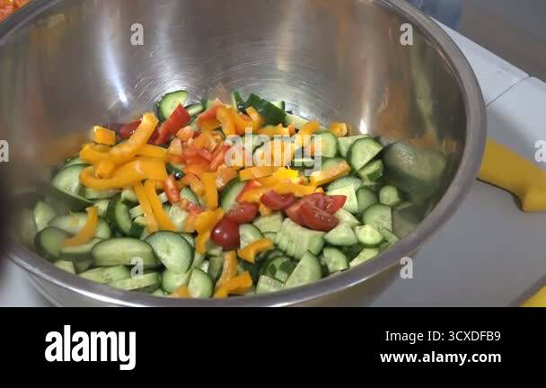 Pomegranate sauce poured over fresh vegetable salad with tomato ...