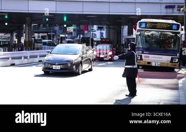 Uniformed officer directing vehicles at a crosswalk Stock Video Footage ...