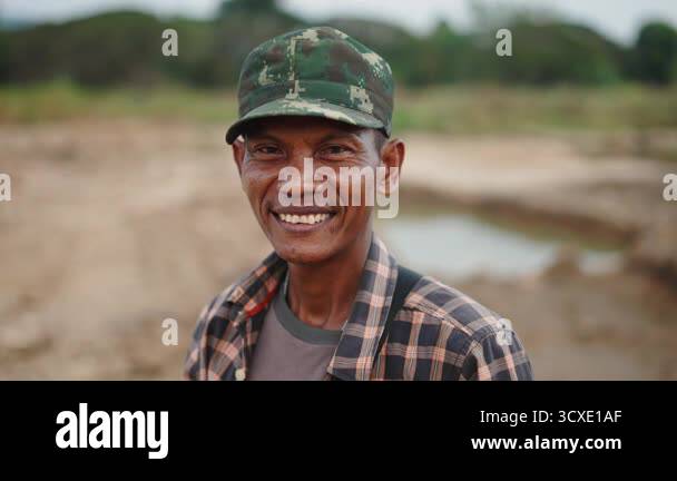 Portrait of an Asian brown skinned older man in Ban Bang Phra wearing a ...