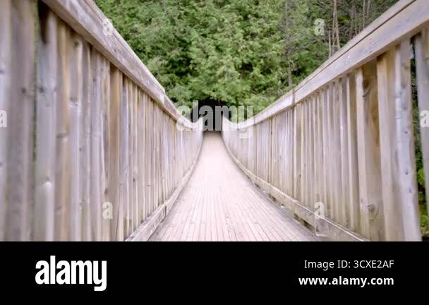 Smooth gimbal walkthrough across the historic wooden bridge at ...
