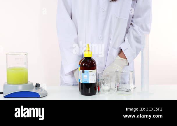 Scientist demonstrates iodine clock reaction changing color from clear ...