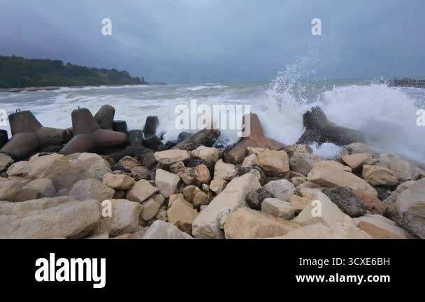 Huge storm waves crashing against rocks on the coast, dramatic view of ...