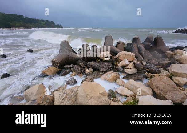Huge storm waves crashing against rocks on the coast, dramatic view of ...