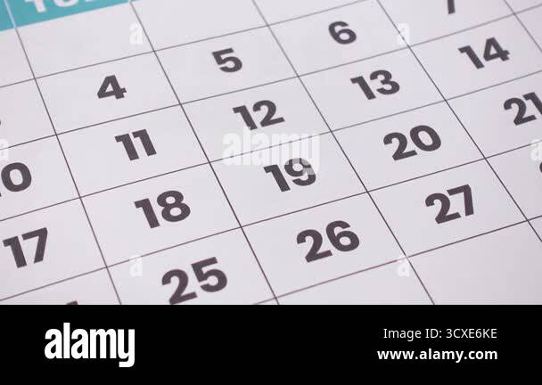 A printed monthly calendar with several dates circled in red ...