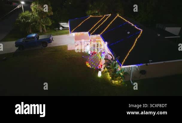 Holiday lights and outdoor Christmas decor shining brightly in front ...