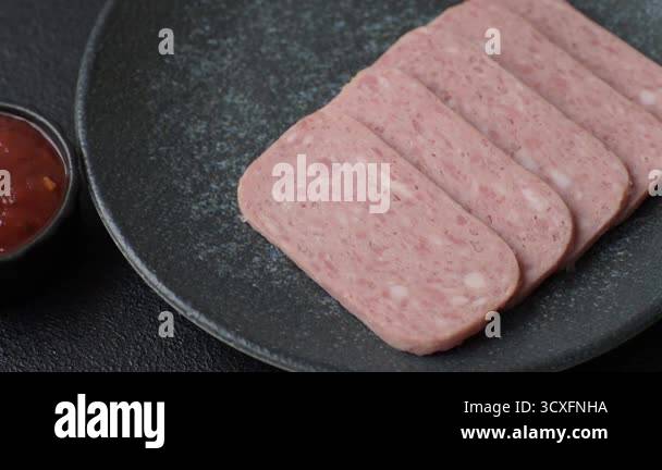 Spiced ham slices, canned meat for lunch sandwiches. Spiced ham as a ...
