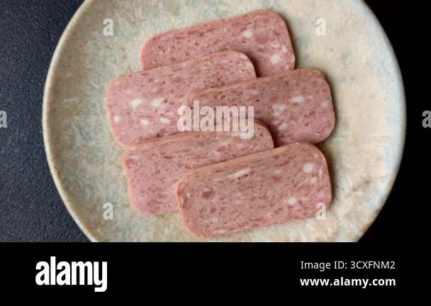 Spiced ham slices, canned meat for lunch sandwiches. Spiced ham as a ...