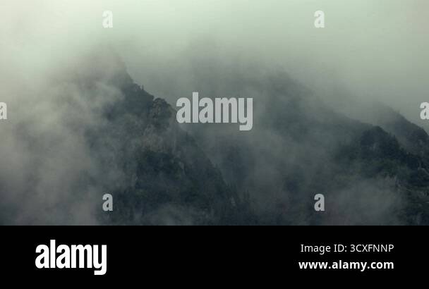 Fog and clouds passing through the mountain forests, misty landscape ...
