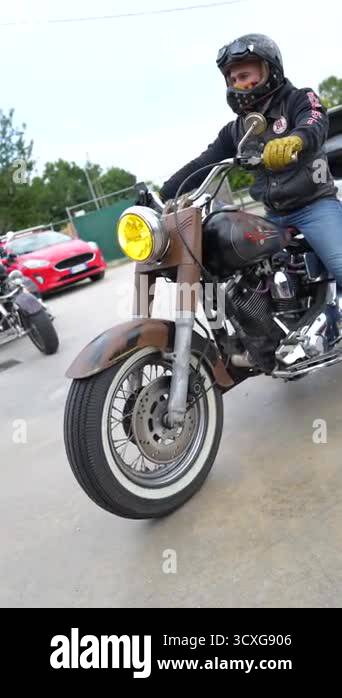 Padova, italy 1 october 2025: young man riding a custom chopper ...