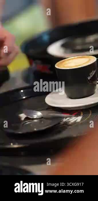 Padova, italy 1 october 2025: waiter's hand taking a tray with cups of ...