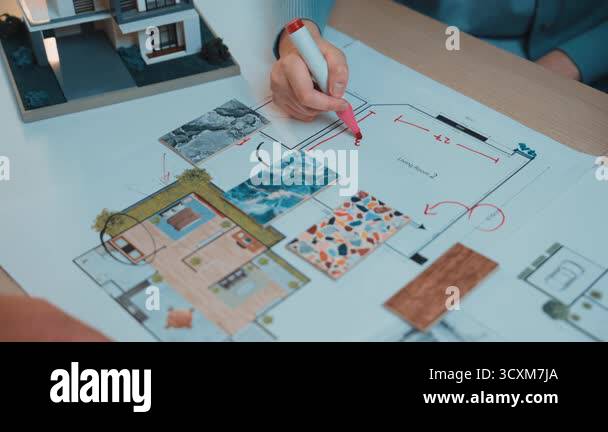 A vibrant scene of professionals analyzing a detailed floor plan for a ...