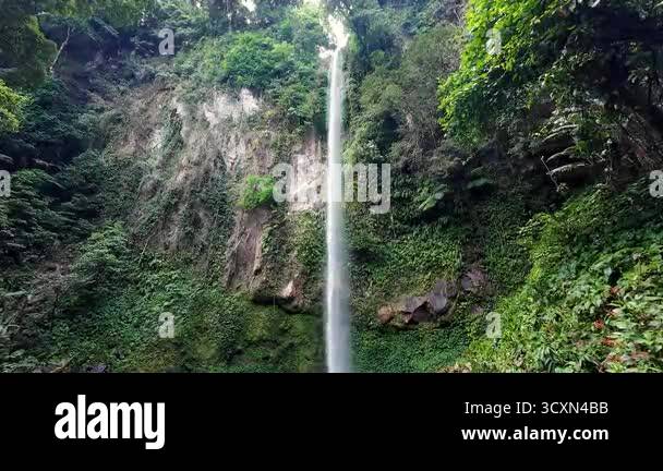 Point of view of huge tropical waterfall and lagoon, clear blue waters ...