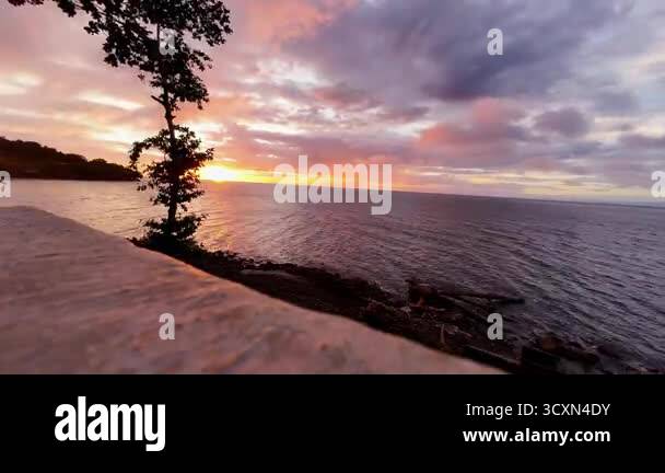 Point of view of tropical sunset in the Philippines with palm tree ...