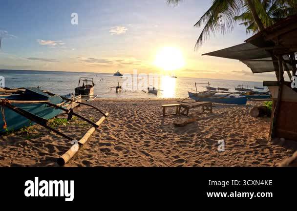 Point of view of tropical sunset in the Philippines with palm tree ...