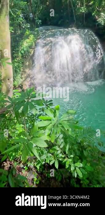 Point of view of huge tropical waterfall and lagoon, clear blue waters ...