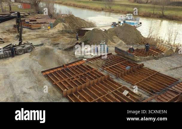 Above view on workers as they cutting parts of old large vessel into ...