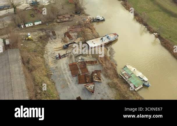 Above view on workers as cutting parts of old large vessel into smaller ...