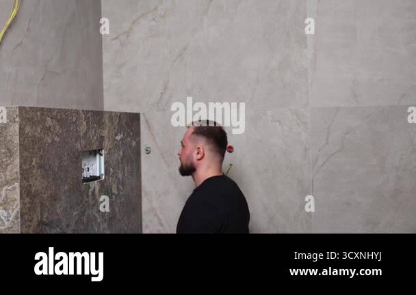 Tiler installing large format tile on bathroom wall Stock Video Footage ...