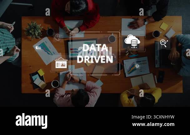 This image captures a diverse team engaged in data-driven strategy ...