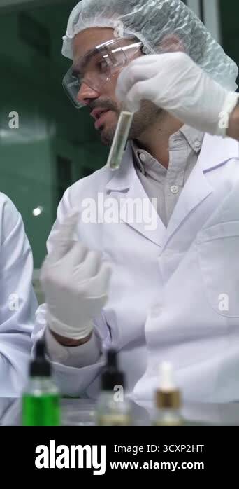 Two scientist in professional uniform working in curative laboratory ...