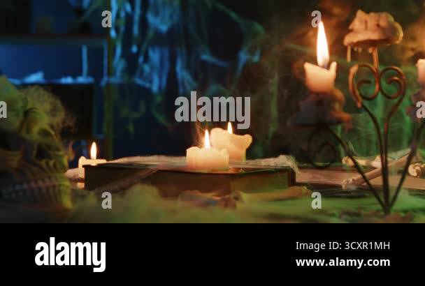 Spooky Halloween scene with lit candles, a skull, and spider webs ...