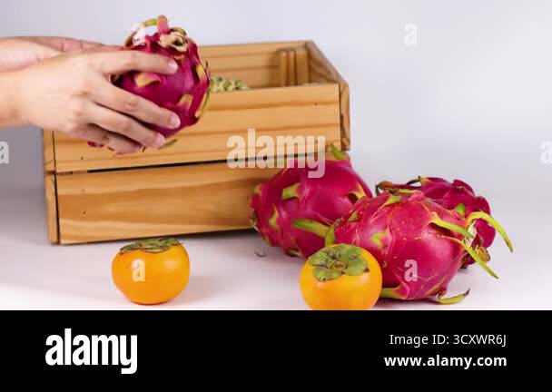 Hands placing fruit into a wooden crate Stock Video Footage - Alamy