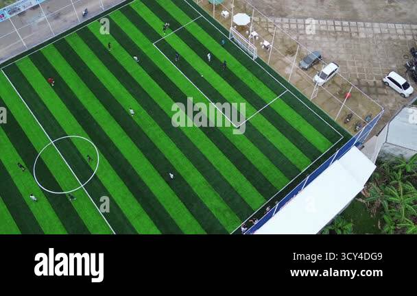 High angle drone shot of a local soccer game. Modern artificial turf ...
