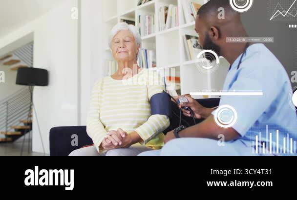 Male nurse wrapping pressure cuff and connecting monitor activating data graphics tracking ...
