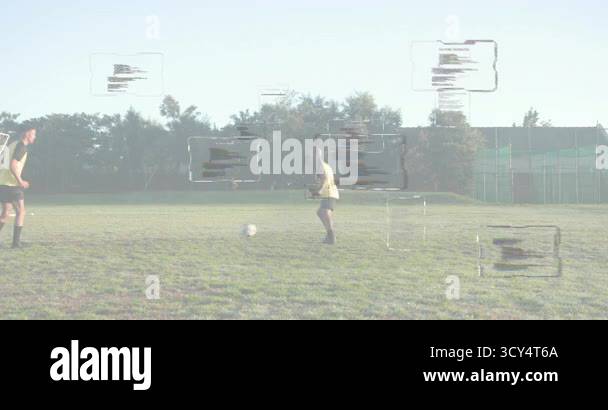 soccer players warming up on pitch for training, ball push initiating ...
