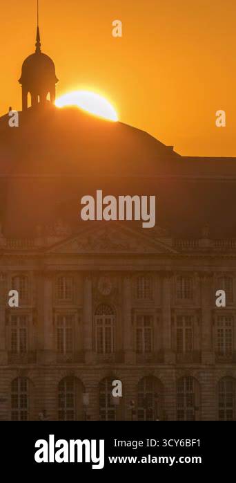 Sunset view of Bordeaux city skyline featuring spires and rooftops on a ...