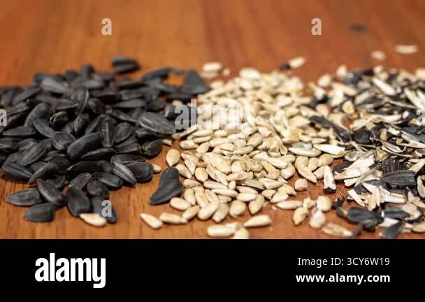 Stop motion animation of sunflower seeds on a brown wooden table ...