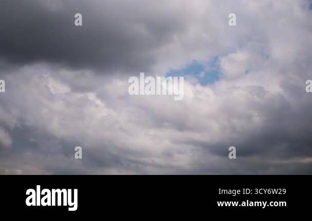 Ominous timelapse of dark grey storm clouds gathering and moving ...