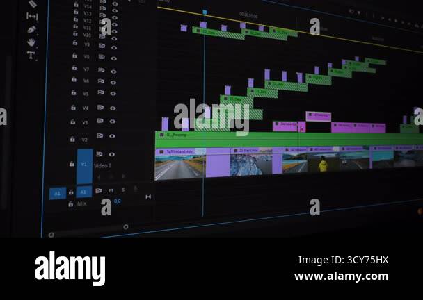 Close-up of detailed multi-track video editing timeline with audio ...