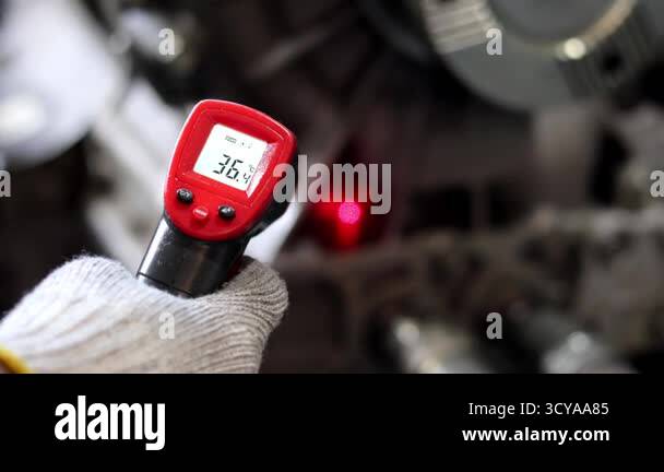 Red infrared thermometer gun showing a temperature reading of 36.3 ...