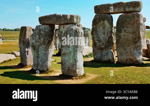 Monolithic sarsen stones forming concentric rings beneath open skies on ...