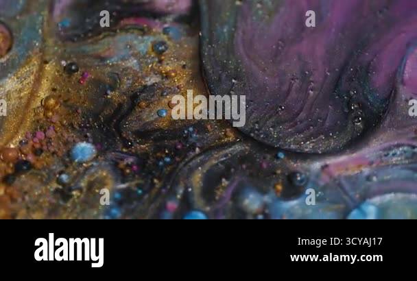 Ink stream. Oil bubbles. Defocused yellow blue purple color acrylic sparkling water glitter flow ...