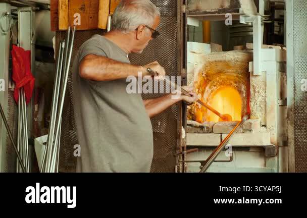 VENICE, Italy, 9 NOVEMBER 2024 - A master glassmaker is seen crafting a ...