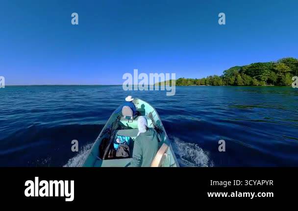 Man driving bass boat while woman seating at the front. Power sport ...